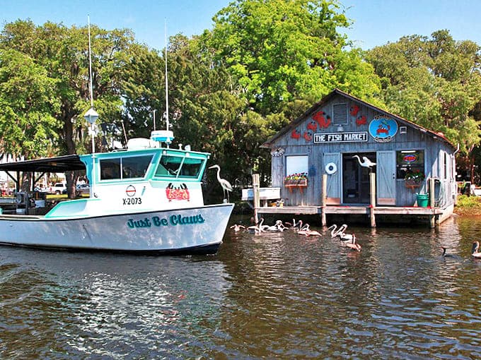 "Just Be Claws" fishing boat rests beside a weathered fish market, the perfect scene from old Florida's working waterfront.