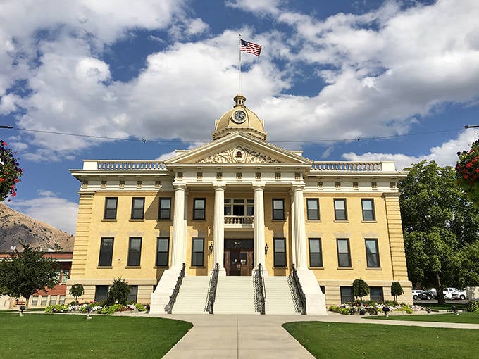 The Box Elder County Courthouse stands proud in butter yellow, its golden dome catching sunlight like a crown.