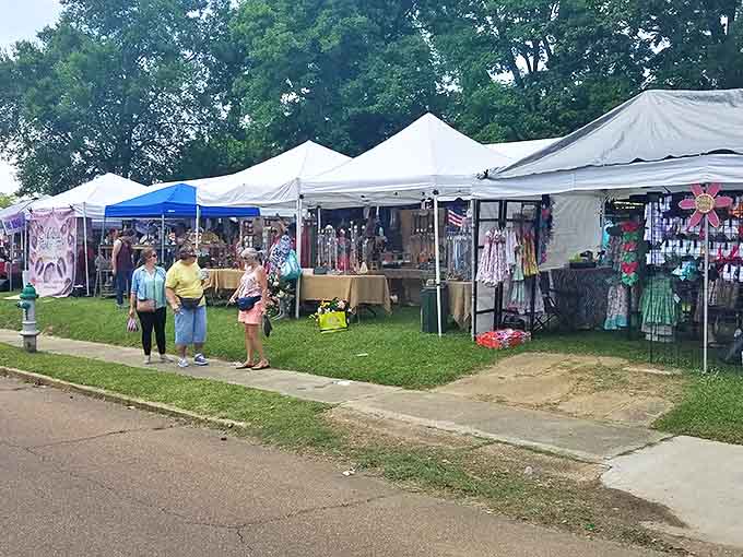 Tents line the grassy edge of Canton Square as shoppers browse handmade crafts, clothing, and decorative items.