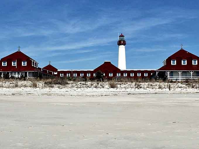 The iconic Cape May Point Lighthouse and red-roofed buildings create a postcard-perfect scene where time stands still by the sea.
