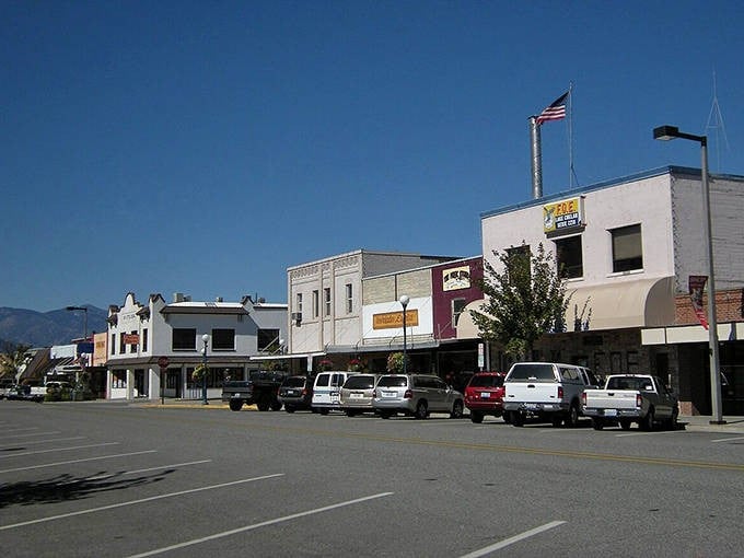 Chelan's sun-drenched main street showcases classic small-town architecture with mountains creating a perfect backdrop for weekend explorers.