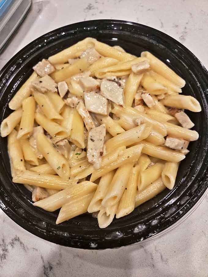 Chicken alfredo pasta that doesn't hide behind fancy plating. Just honest, creamy comfort in a to-go container that somehow tastes even better at midnight.