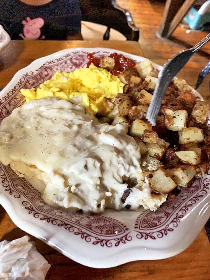 Biscuits swimming in creamy sausage gravy alongside sunny eggs and home fries. Southern comfort meets Vermont hospitality on a plate that screams "nap time later!"