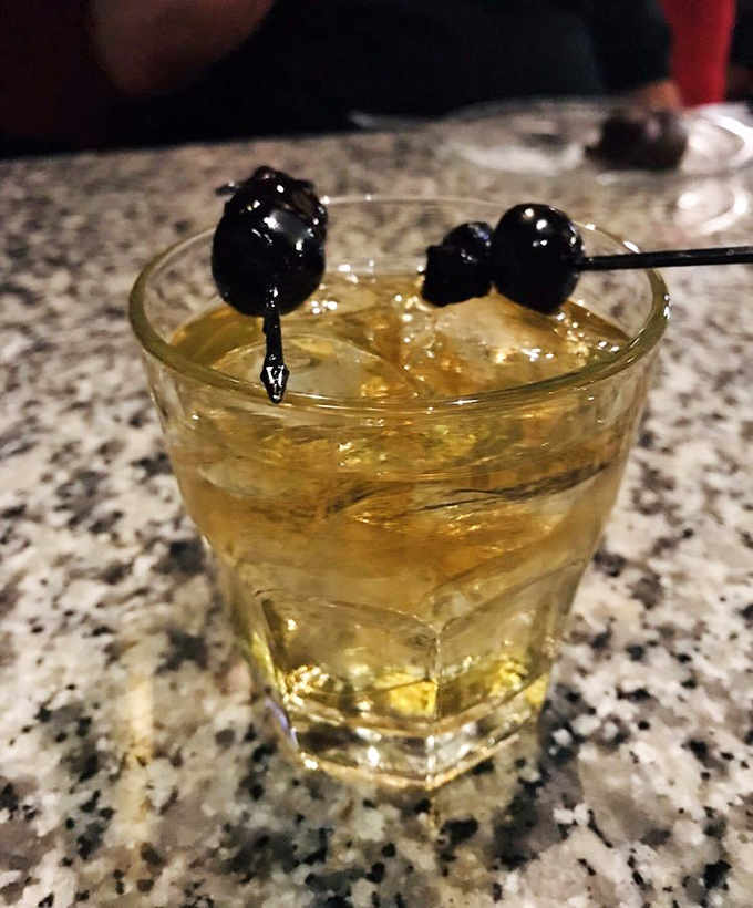 This cocktail, with its fancy black cherries, isn't just a drink &ndash; it's an invitation to linger a while longer.