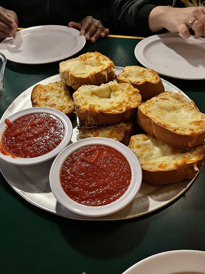 Cheese garlic bread that deserves its own fan club—golden, bubbling perfection with marinara sidekicks standing by for the perfect dip.