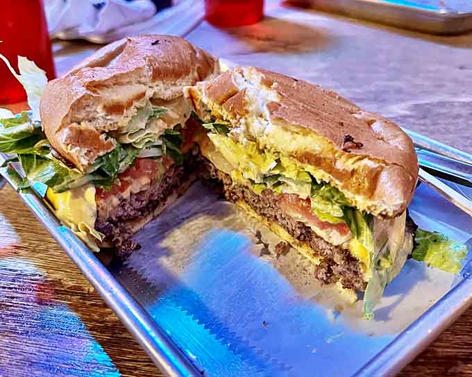 This burger, cut in half to reveal its secrets, is architectural perfection. The structural integrity alone deserves an engineering award.