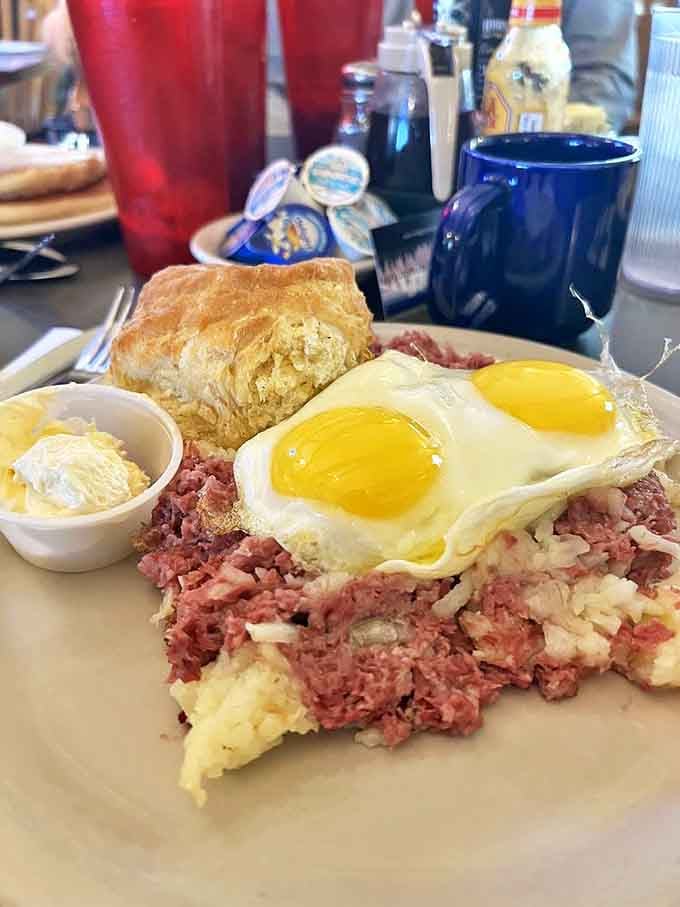 Corned beef hash topped with sunny-side-up eggs&mdash;a plate that says "You won't need lunch today" in the most delicious way possible.