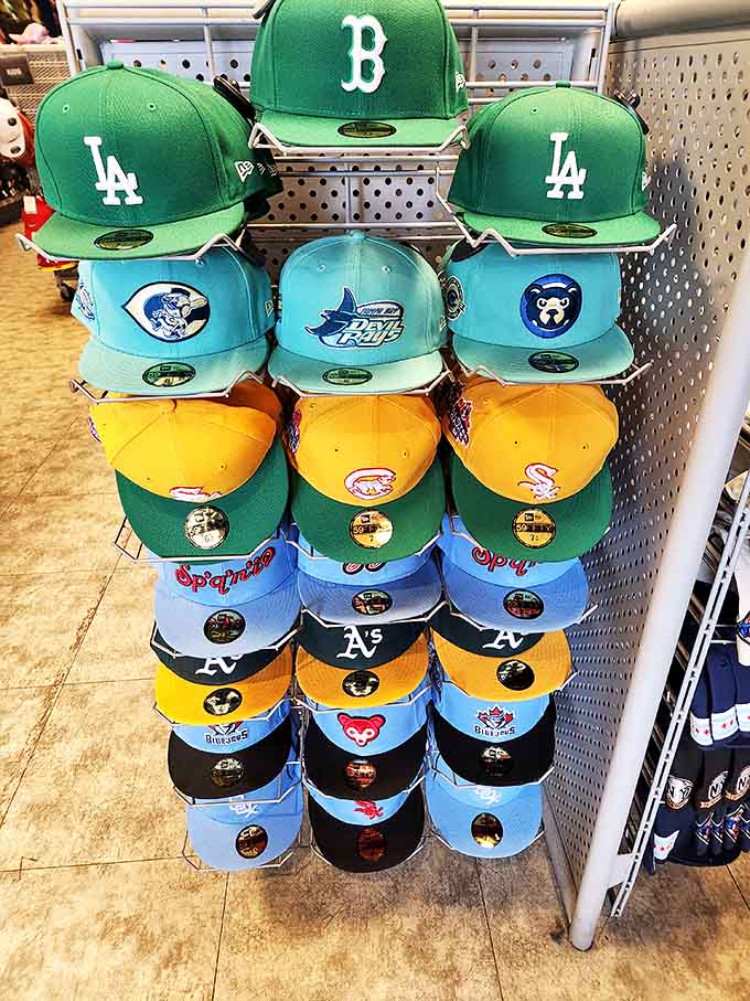 Baseball caps stacked in team colors &ndash; where sports rivalries are temporarily forgotten in the shared joy of finding the perfect fit.