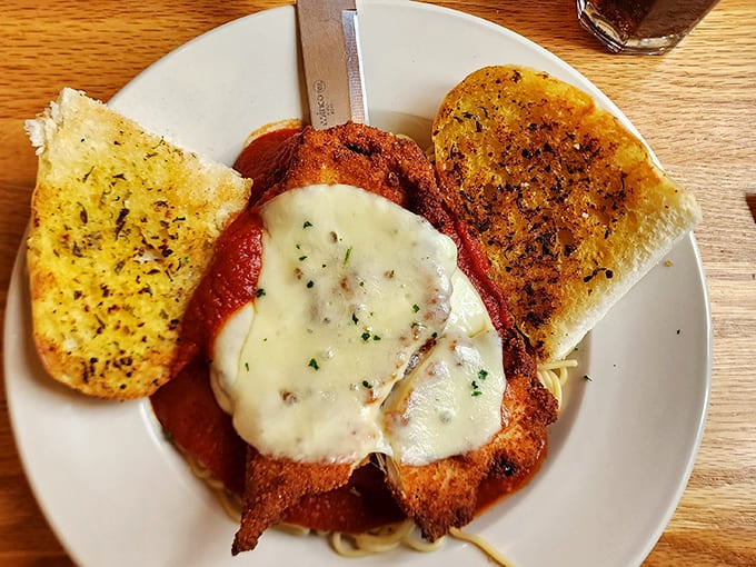 Chicken Parmesan that doesn't mess around&mdash;crispy cutlet, melty cheese, and garlic bread that means serious comfort business.