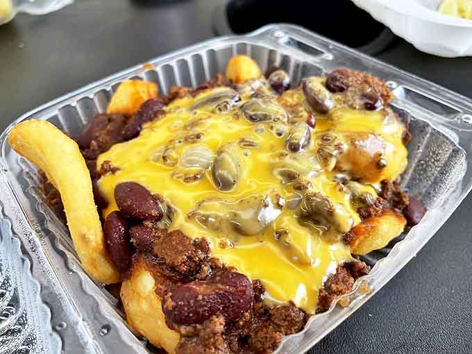 Chili cheese fries' sophisticated island cousin—potato dippers smothered in beefy chili and melted cheese that would make a cardiologist wince and smile simultaneously.