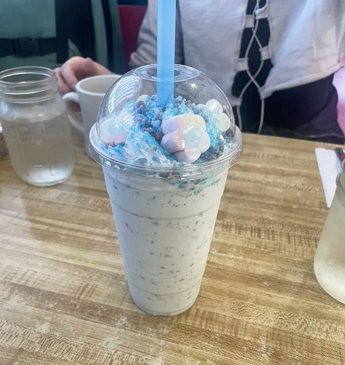 The cotton candy shake looks like it escaped from a carnival and went to culinary school &ndash; a whimsical, pastel-blue creation topped with clouds of sweetness.
