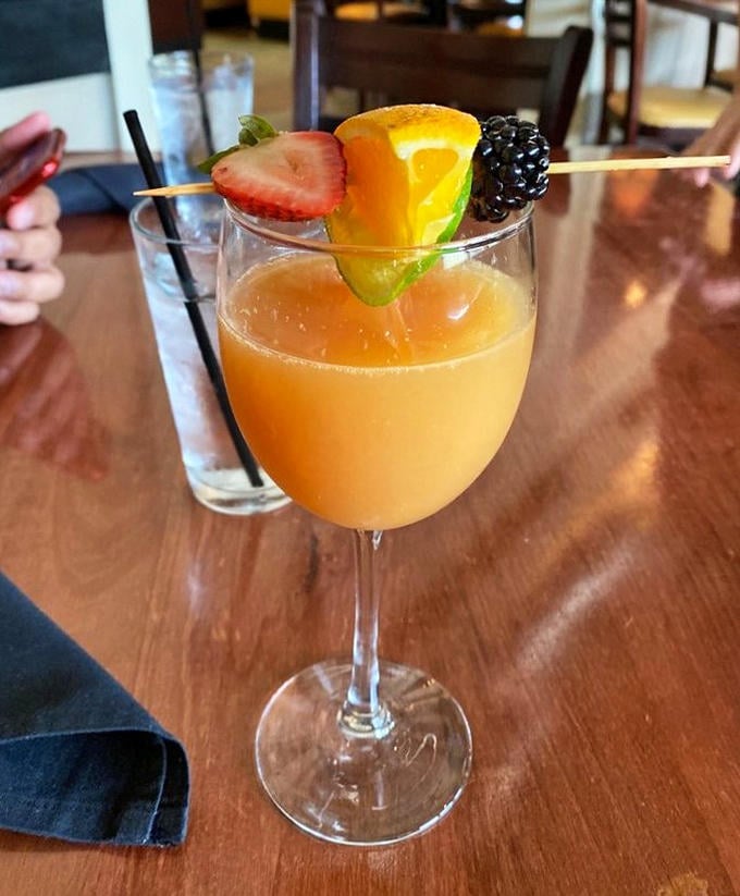 A mimosa garnished like it's headed to a fruit parade&mdash;because sometimes breakfast deserves a standing ovation and a little champagne.