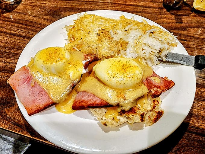 Eggs Benedict: the aristocrat of breakfast dishes, where hollandaise sauce flows like liquid gold over English muffins.