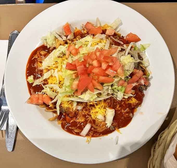 The humble Frito Pie, elevated to art form. Crispy corn chips meet savory red chile in a relationship more satisfying than most marriages.