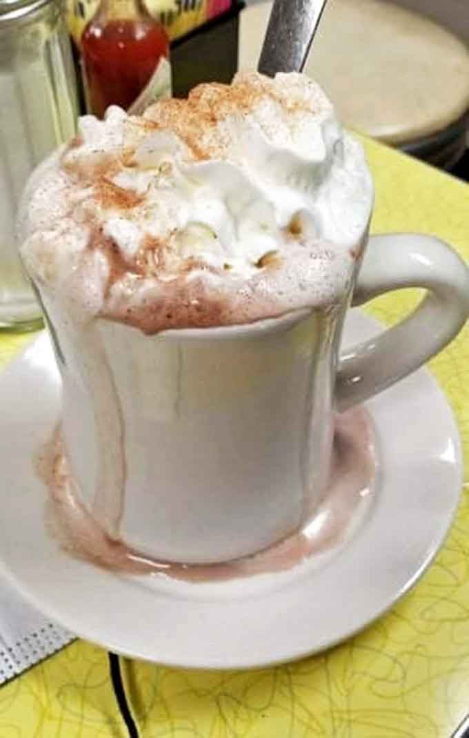 This isn't just hot chocolate&mdash;it's a warm hug in a mug, topped with a cloud of whipped cream dusted with cinnamon.