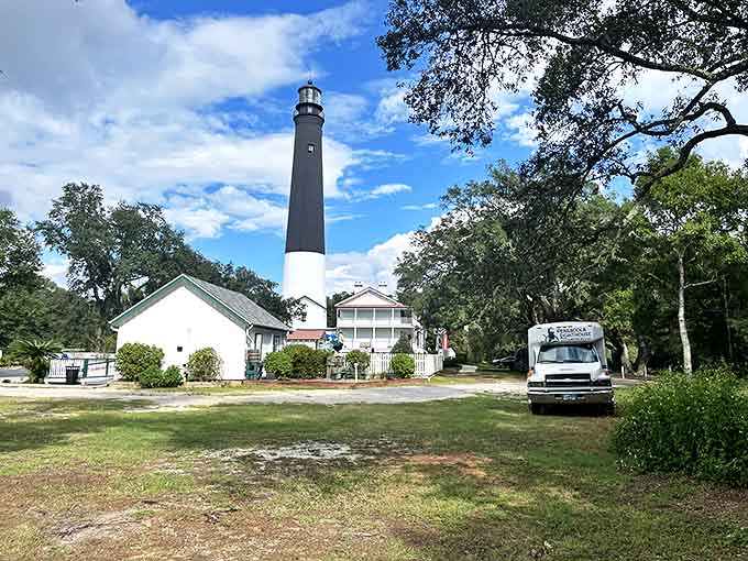 The Pensacola Lighthouse stands tall like that friend who always knows the way home, guiding visitors with its classic black-and-white profile.