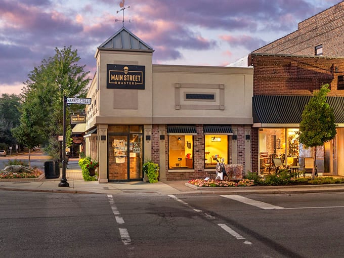 Main Street Roasters glows like a beacon at dusk, promising locally roasted beans and pastries that make chain coffee shops seem like sad, distant relatives.