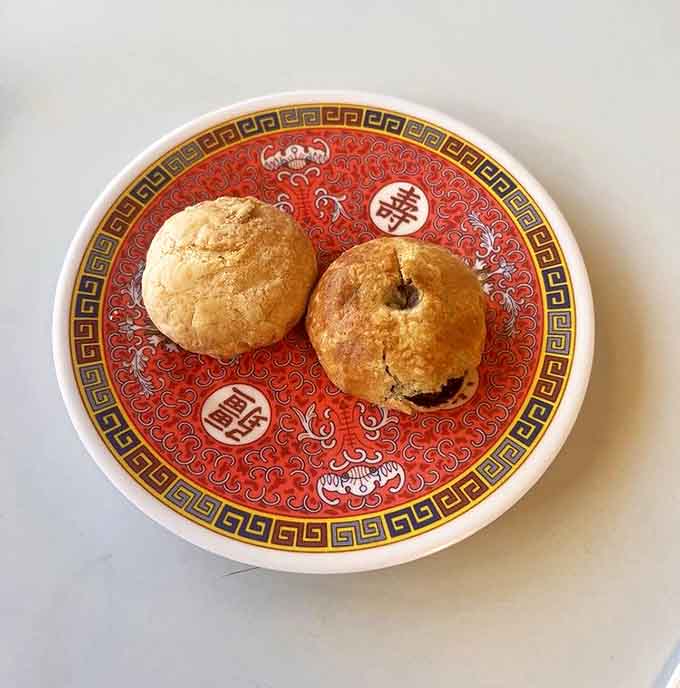 Manju pastries on a decorative plate&mdash;golden, flaky treasures filled with sweetened bean paste. Dessert that doesn't shout, but quietly impresses.
