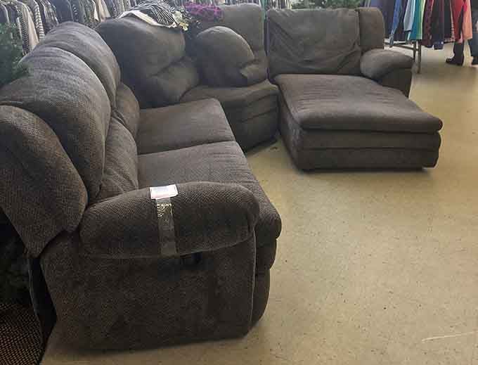 The furniture section's sectional sofa silently promises Netflix marathons and unexpected naps to whoever gives it a second home.