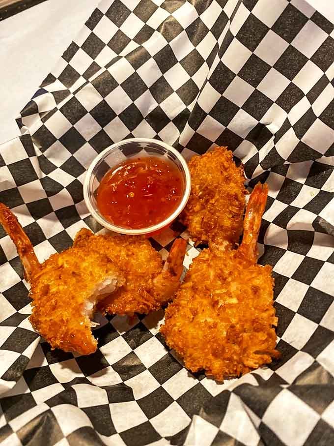 Coconut shrimp that could convert even the most dedicated landlubber. That crispy exterior hiding sweet, tender seafood is culinary poetry.