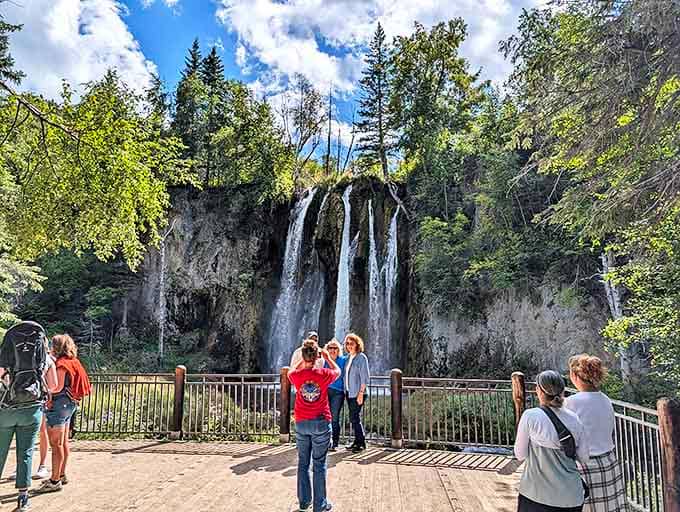 Visitors gather at the waterfall viewpoint, proving that Mother Nature's greatest hits tour still draws crowds. No ticket required, just comfortable shoes.