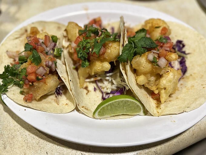 Fish tacos that dance on your palate. Three perfect bites of crispy, tangy, creamy goodness with a squeeze of lime for good measure.