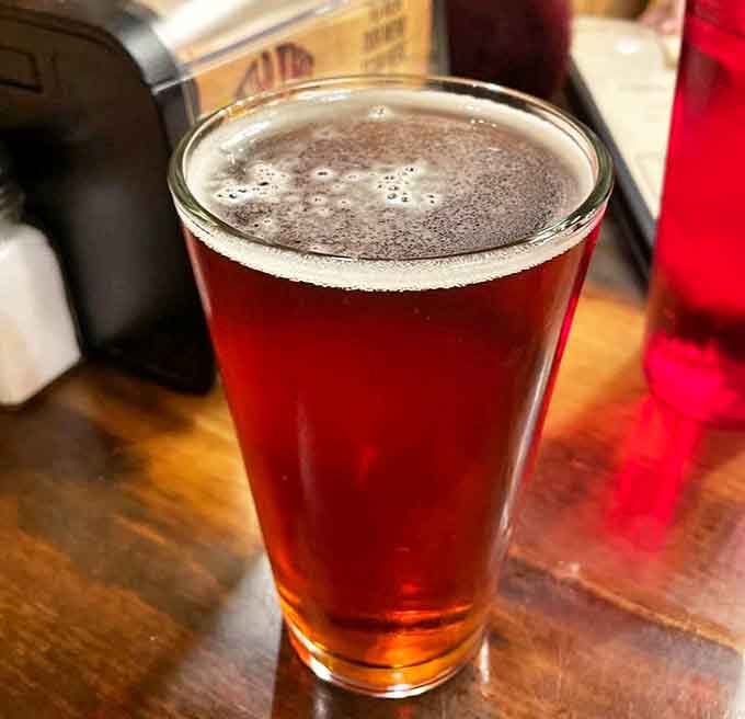 Amber liquid gold in a glass—the perfect Montana craft beer companion for your pizza adventure, promising refreshment after a day of wilderness exploration.