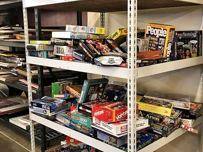 Board games and puzzles stacked like a analog entertainment library &ndash; before Netflix, this was how families survived rainy weekends.