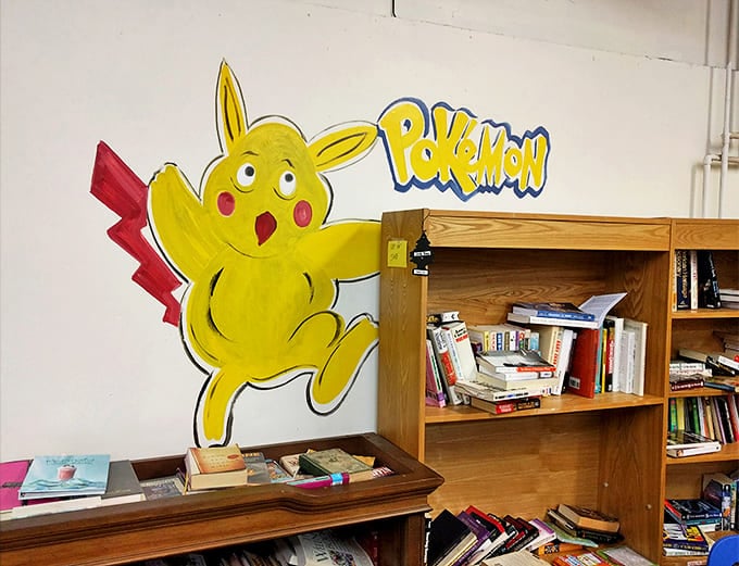 Pikachu guards literary treasures with wide-eyed enthusiasm. Even fictional pocket monsters understand the joy of finding a perfectly broken-in paperback.
