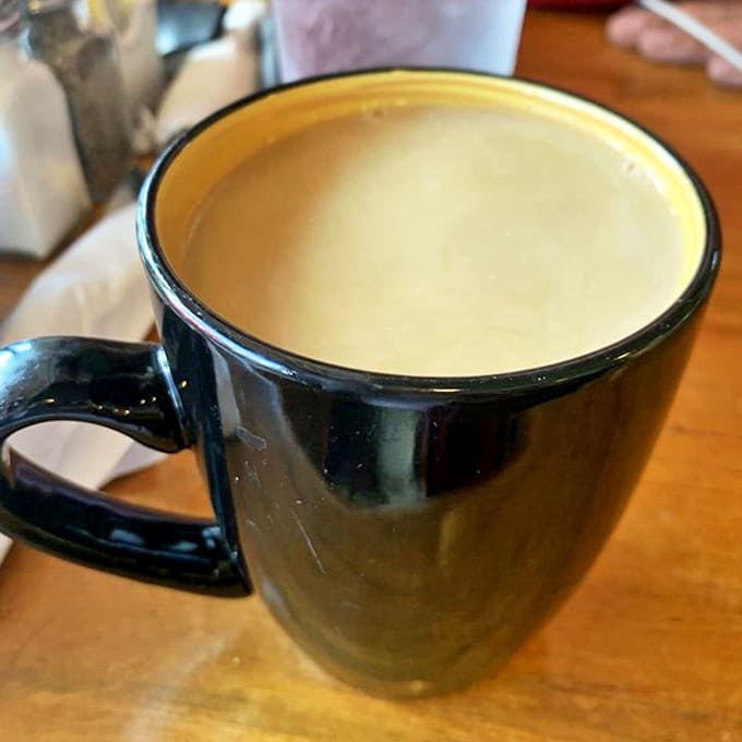 The humble coffee mug contains liquid motivation, served hot and frequently refilled—the unsung hero of every mountain morning adventure.