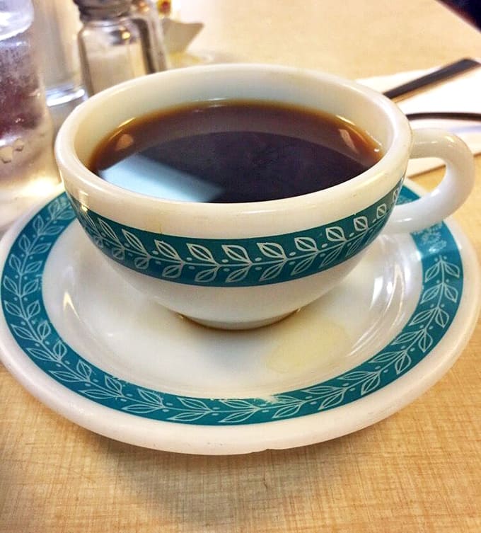 Even the coffee comes in those iconic blue-patterned cups, a humble companion to the seafood feast that somehow feels exactly right.