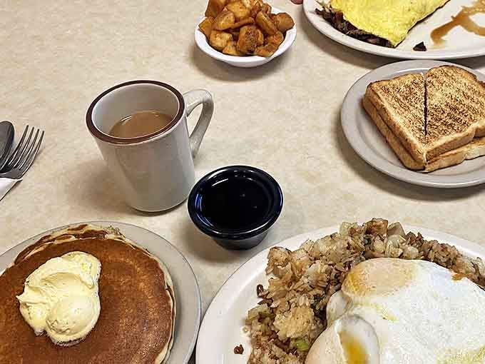 A breakfast spread that tells the whole story &ndash; pancakes, eggs, hash browns, and coffee, the four food groups of morning happiness.