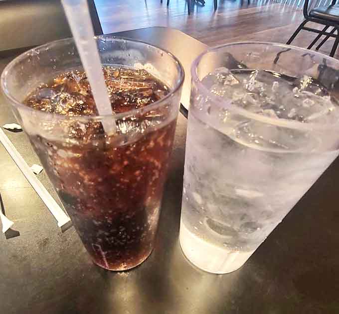 Simple pleasures in tall glasses: ice-cold soda and water, the unsung heroes of any great diner meal. Refreshment at its most honest.