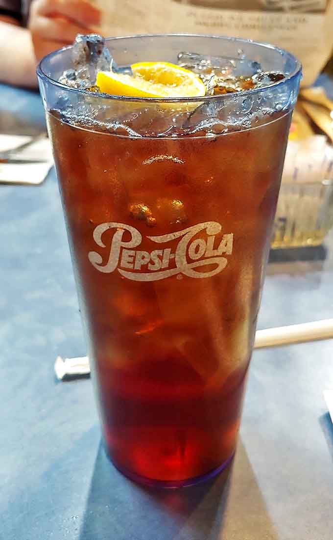 That isn't just a Pepsi – it's a properly served fountain drink with ice that crackles and a lemon wedge that means business. Simple pleasures done right.