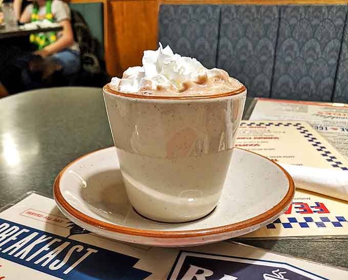 Hot chocolate that doesn't just warm your hands but your soul—topped with a cloud of whipped cream that's practically begging to leave a mustache.
