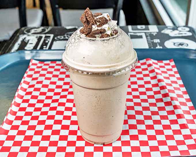 This isn't just a milkshake&mdash;it's dessert with a straw, crowned with whipped cream and cookie crumbles, demanding both patience and appreciation.