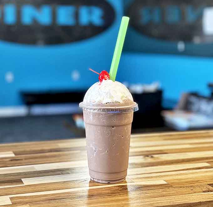 Milkshakes thick enough to require serious straw commitment. The whipped cream and cherry say "dessert," but we won't judge your breakfast choices.