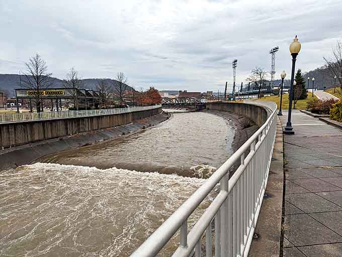 The riverside walkway offers front-row seats to nature's daily performance&mdash;water rushing past concrete in a dance as old as the hills.
