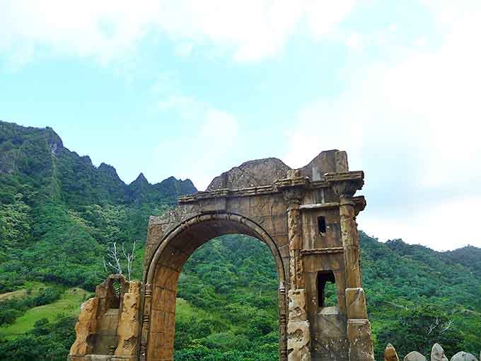 Ancient meets modern in this crumbling stone archway. Like finding Roman ruins in paradise, it whispers stories of bygone eras against a backdrop of eternal green.