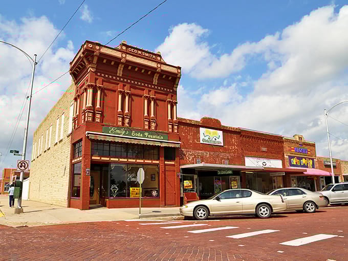 The ornate corner building in Broken Bow houses a classic soda fountain, where brick streets and vintage storefronts create timeless Nebraska charm.