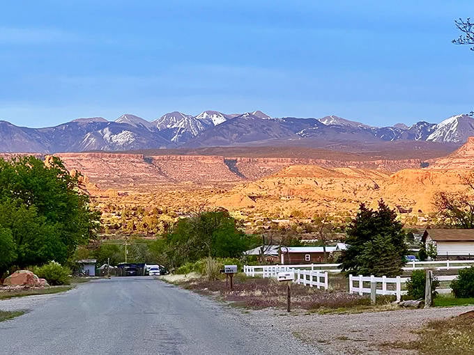 Red rock cliffs tower behind this quiet Moab neighborhood where desert meets mountain in spectacular fashion.