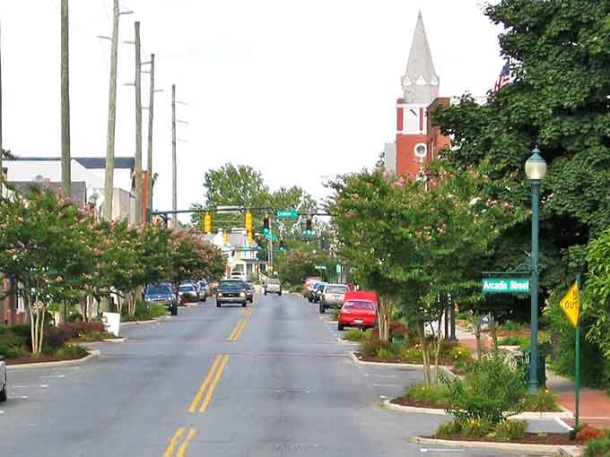 Seaford's tree-lined Main Street beckons with its historic church spire standing tall against the sky—small-town perfection.