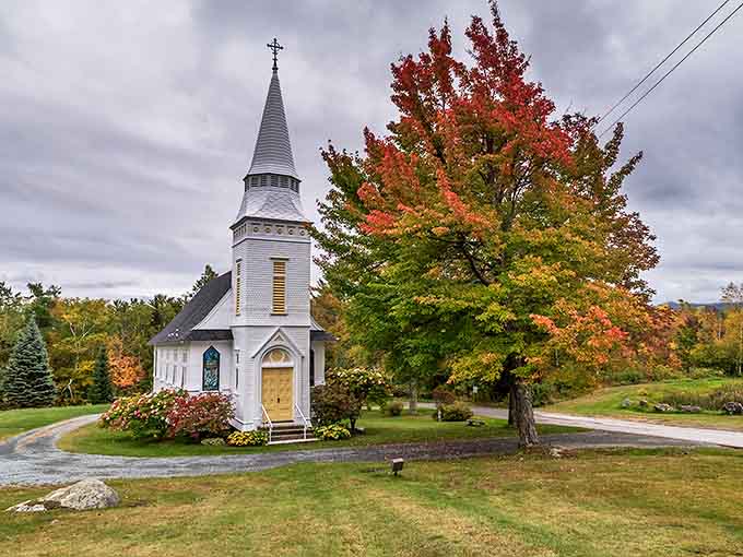 Sugar Hill's pristine white chapel stands like a beacon against autumn's fiery display &ndash; Norman Rockwell couldn't have painted it better.
