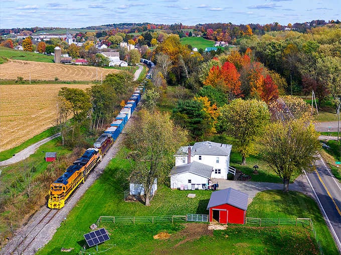 Freight trains rumble past farmsteads, creating a uniquely American symphony of progress and timeless tradition.