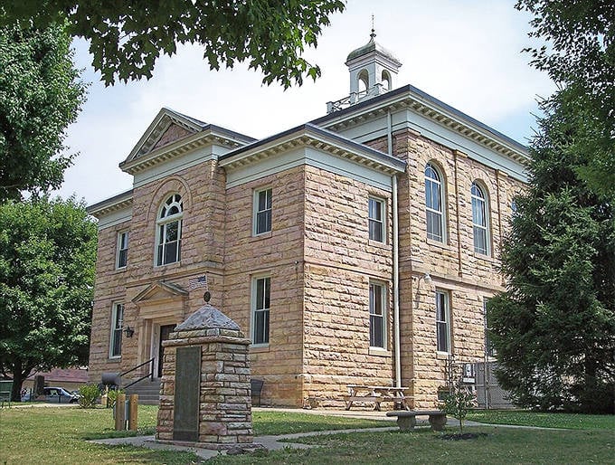 The Summersville Courthouse stands like a sentinel of justice, its sandstone walls glowing warmly in the afternoon light.