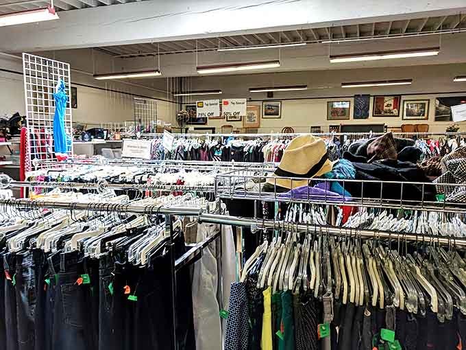 Neatly arranged clothing racks showcase the careful organization that makes this thrift store special.