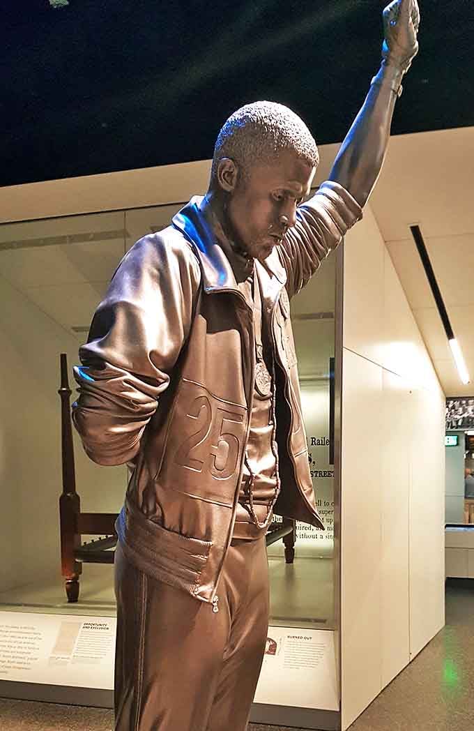 This powerful bronze statue captures a moment of triumph, a testament to the cultural contributions celebrated at the African American Museum of the Arts.