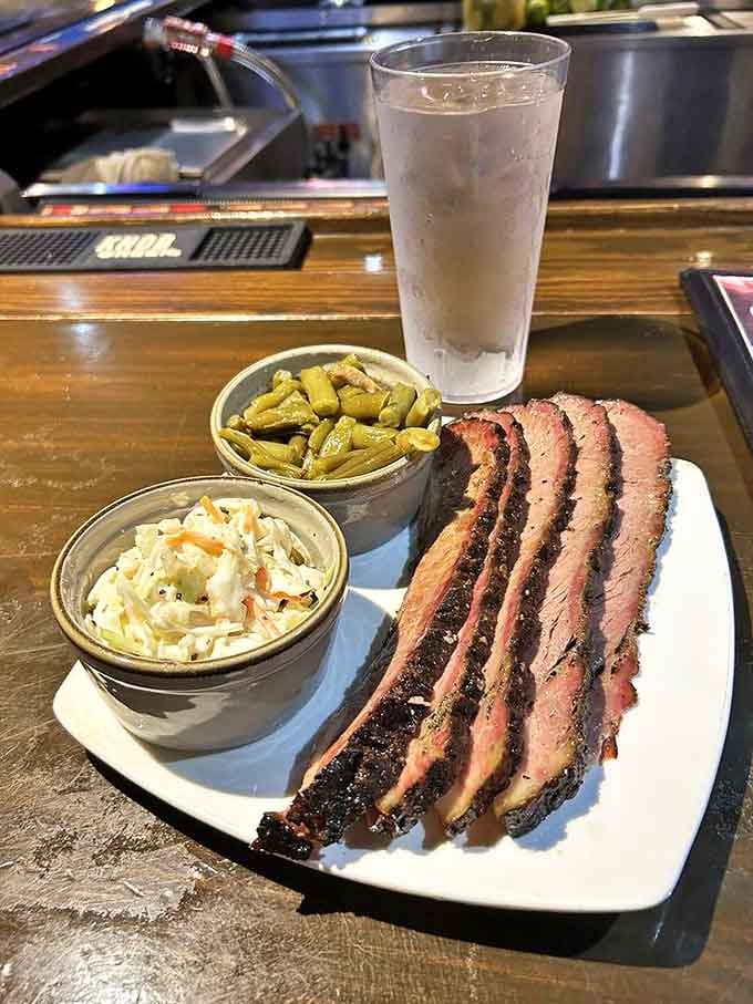 Brisket sliced thin enough to read through but packed with enough flavor to write home about. The smoke ring is practically a halo.