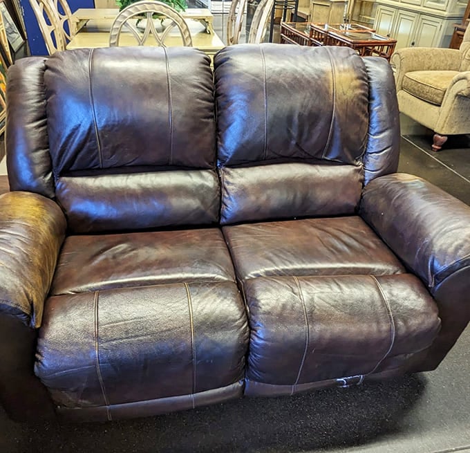 This leather loveseat has stories to tell. Slightly worn but impossibly comfortable, it's waiting for your living room and Netflix marathons.
