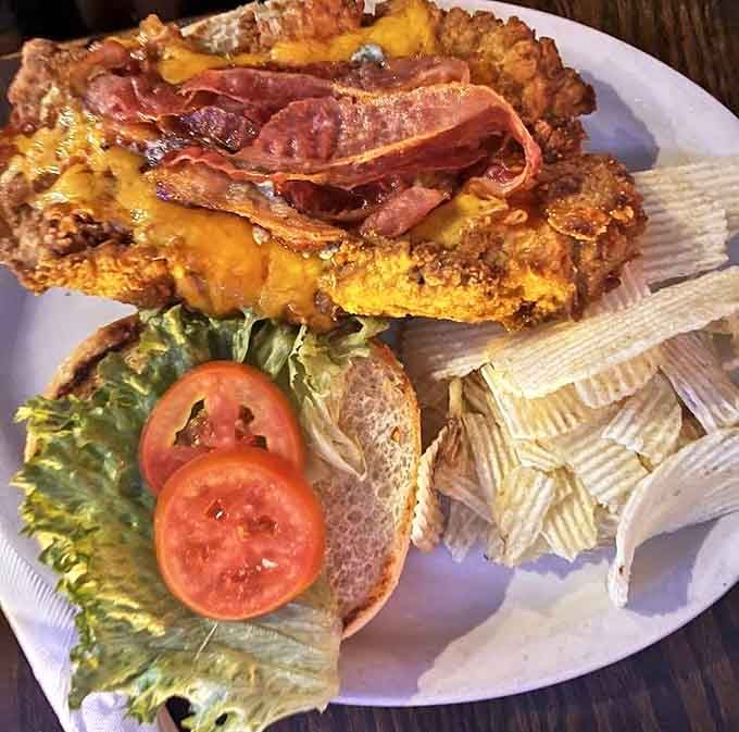 The Buffalo tenderloin sandwich – where crispy coating meets melty cheese meets bacon in a harmony so perfect it deserves its own musical.